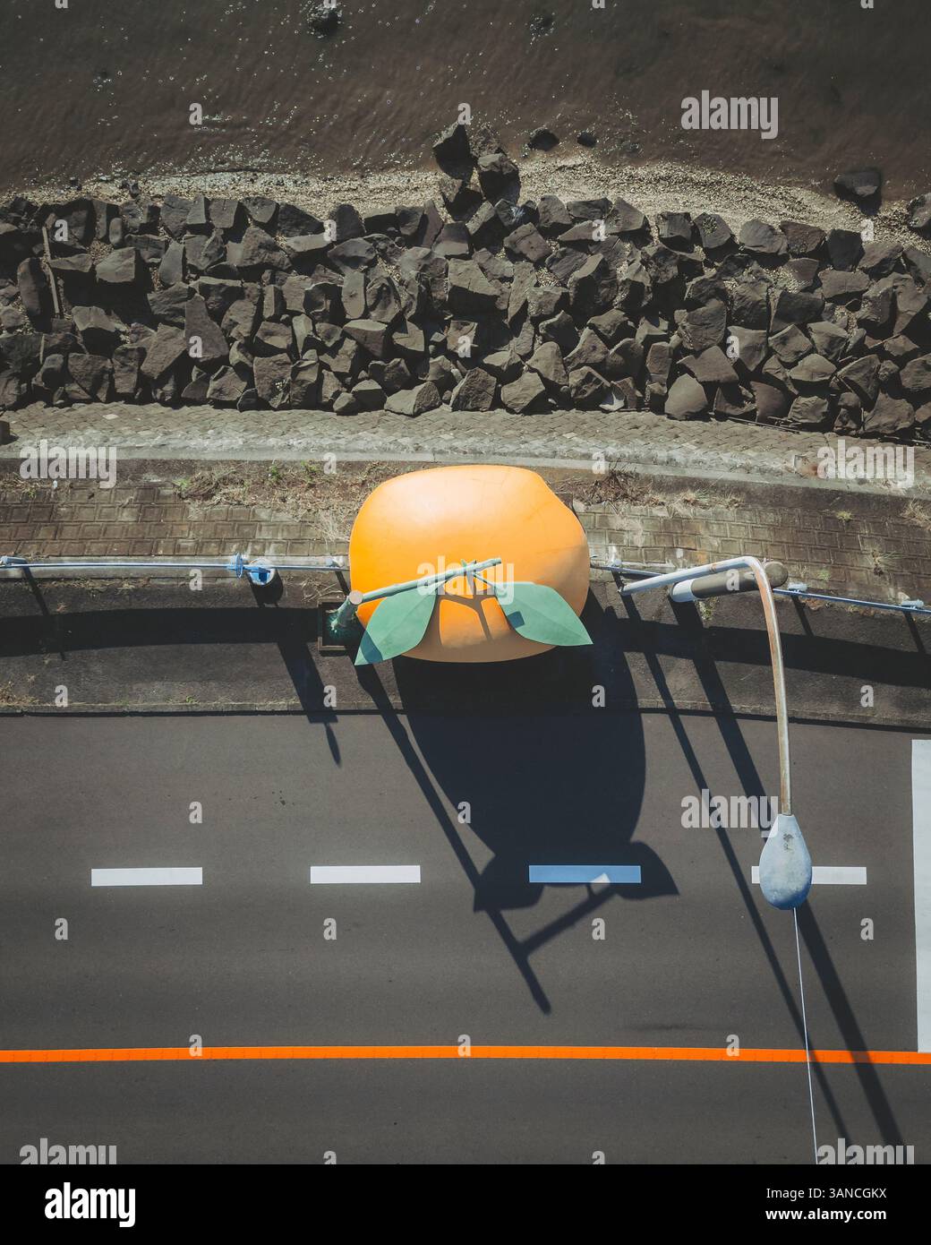 Aerial topdown shot of an Orange shaped bus stop in Konagai, Nagasaki ...