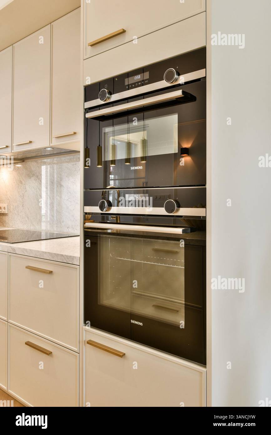 A sleek and contemporary kitchen featuring elegant cabinetry ...