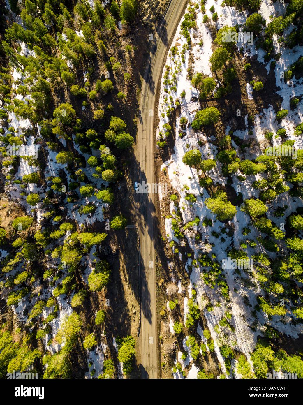 Aerial view of the snowy road with a panorama to Roof Butte, Arizona ...
