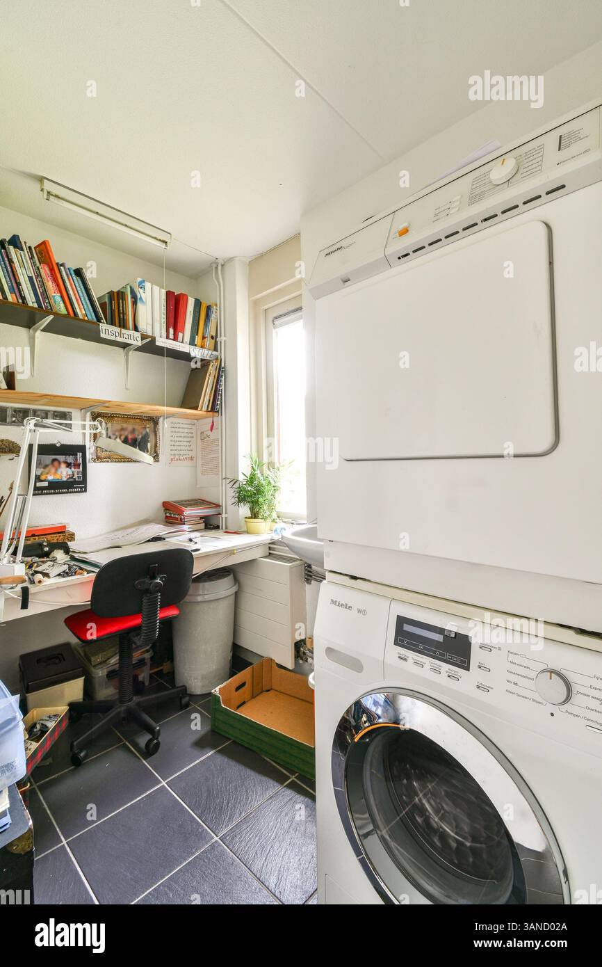 A well-organized modern home office featuring a desk, bookshelves, and ...