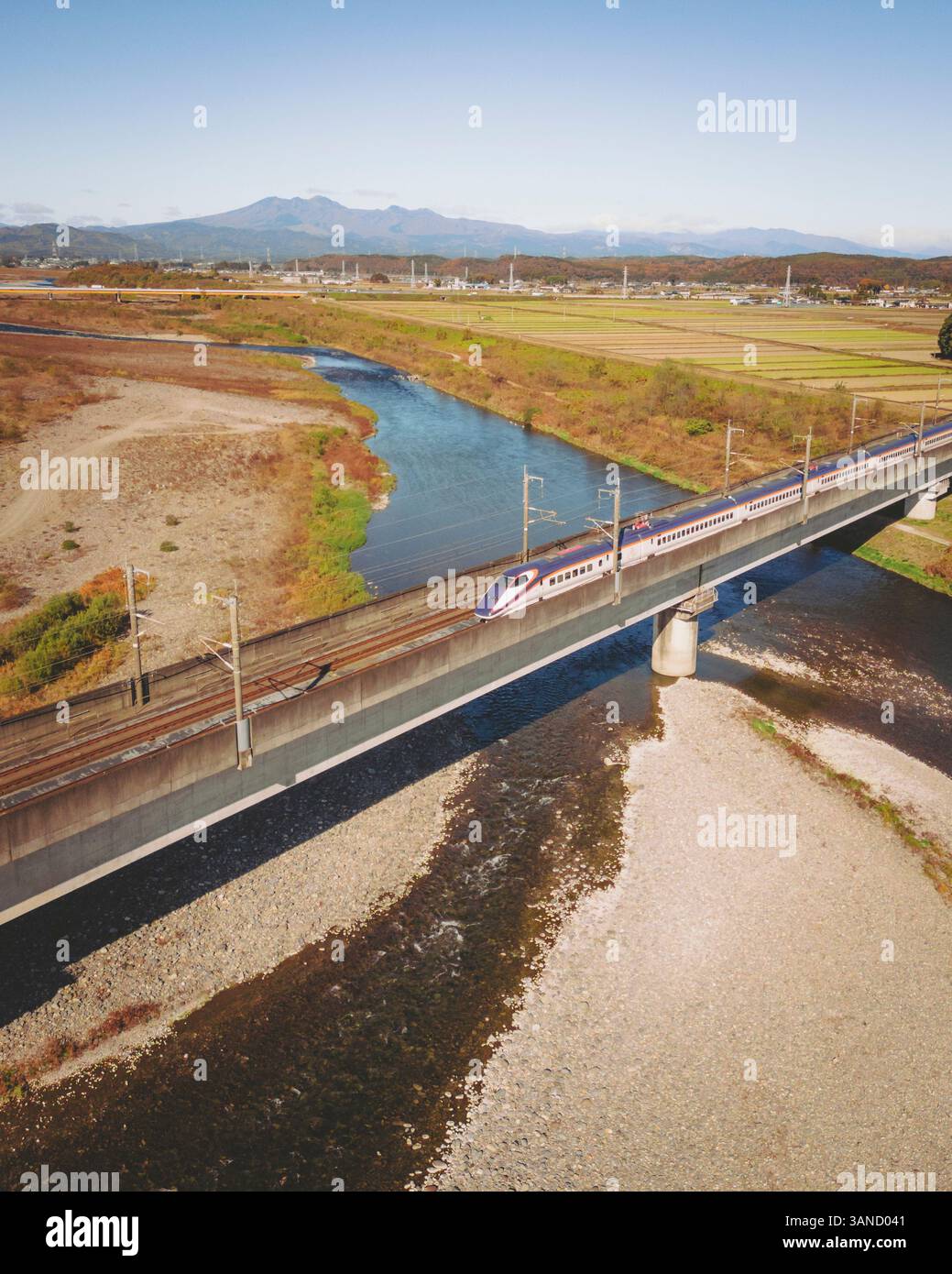 Aerial view of the Tohoku Shinkansen bullet train on a bridge, Tochigi ...