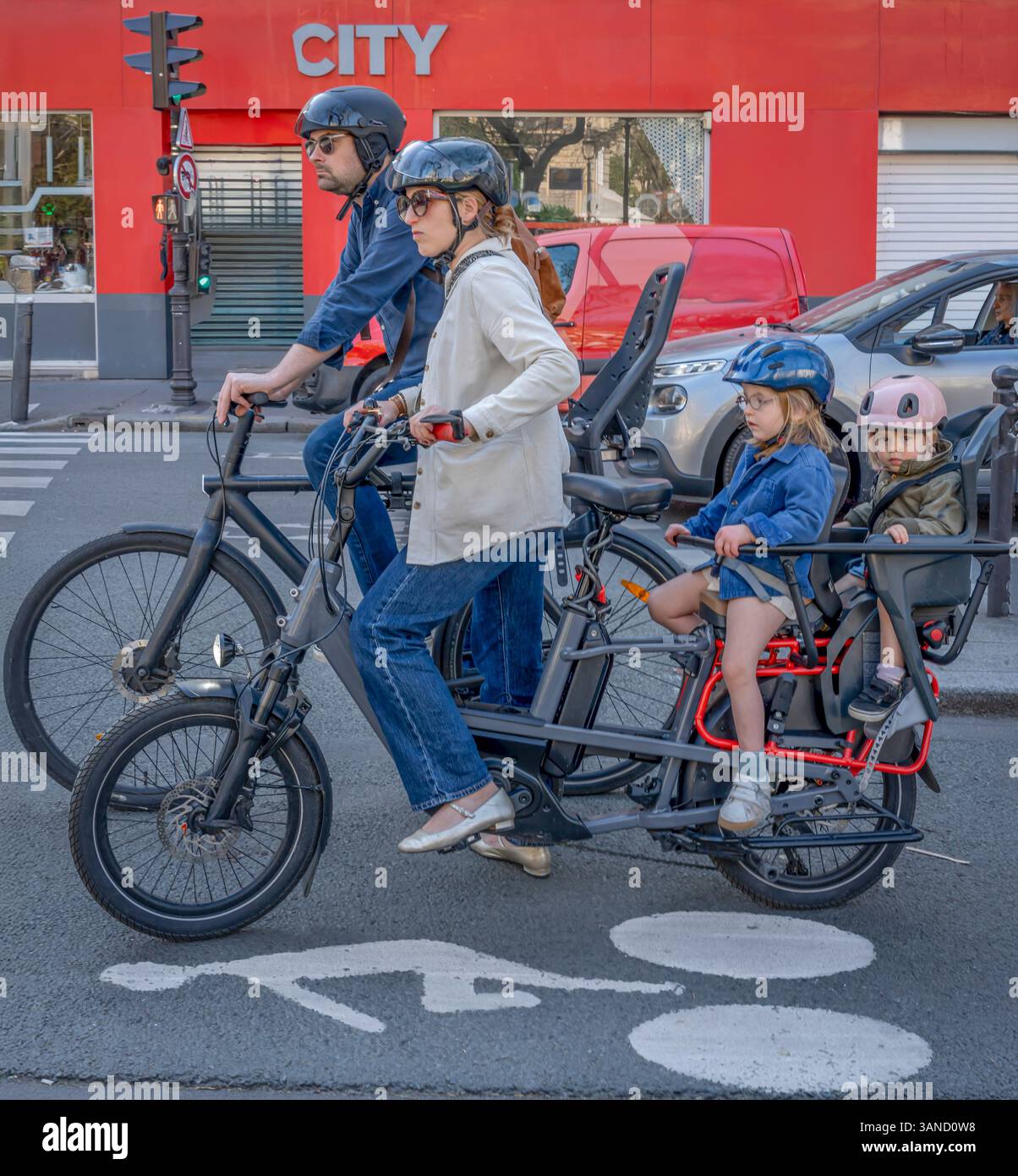 Paris, France - 04 05 2025: Slow traffic. A man, a woman and two small ...