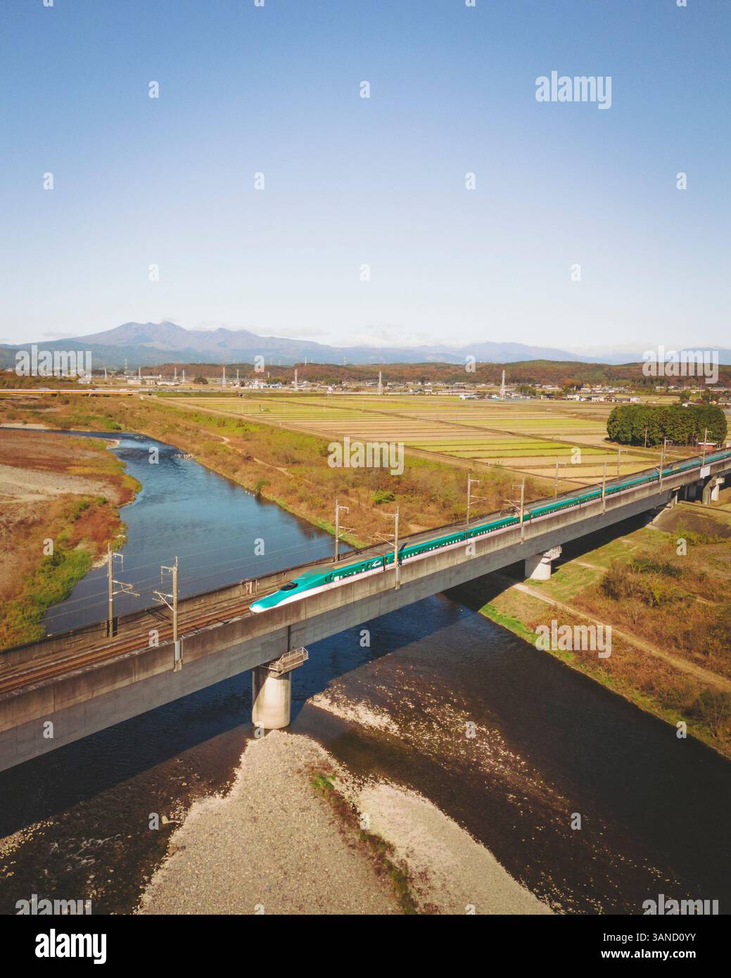 Aerial view of the Tohoku Shinkansen bullet train on a bridge, Tochigi ...