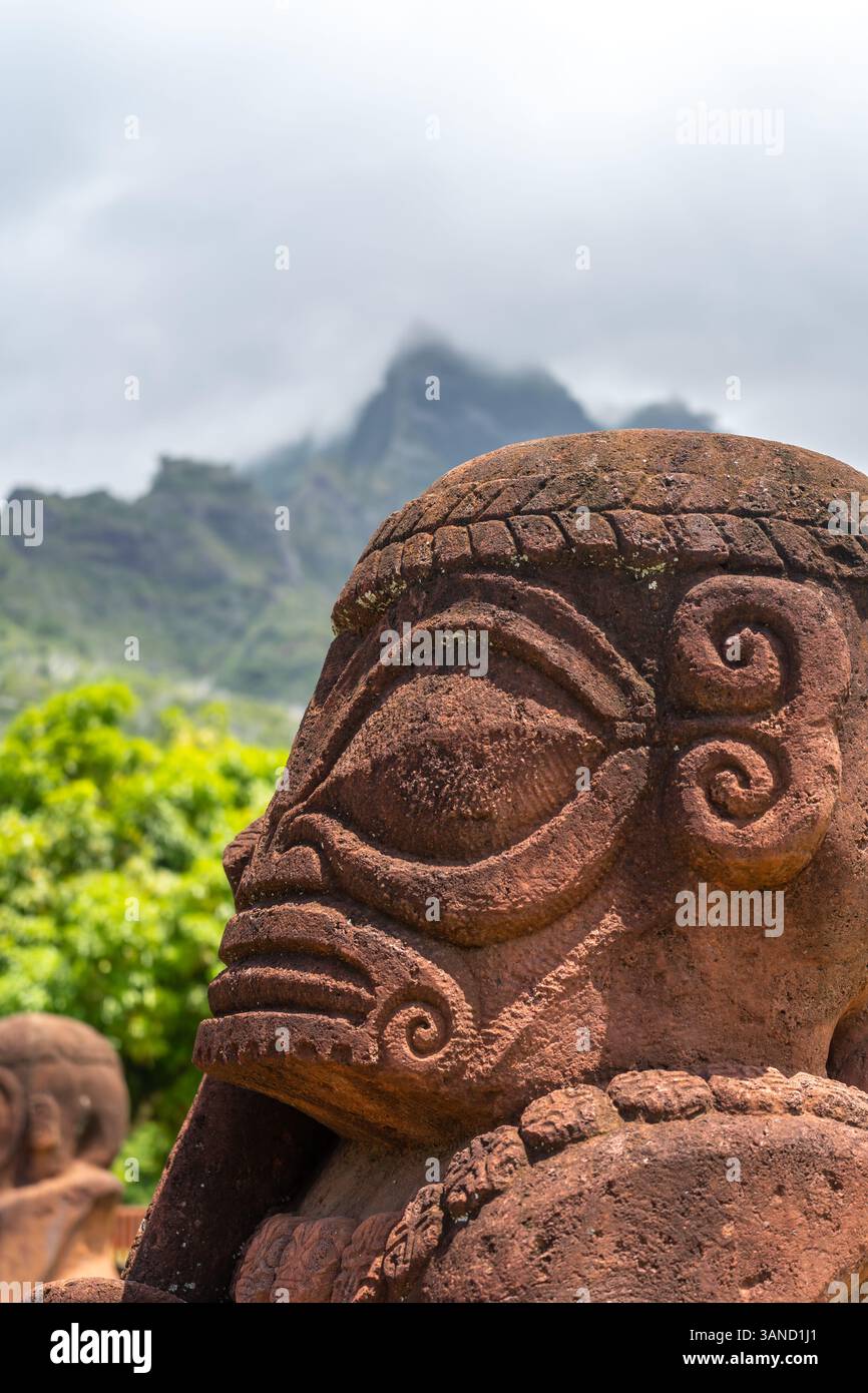 A majestic tiki statue stands before Mount Temetiu on Hiva Oa, French ...