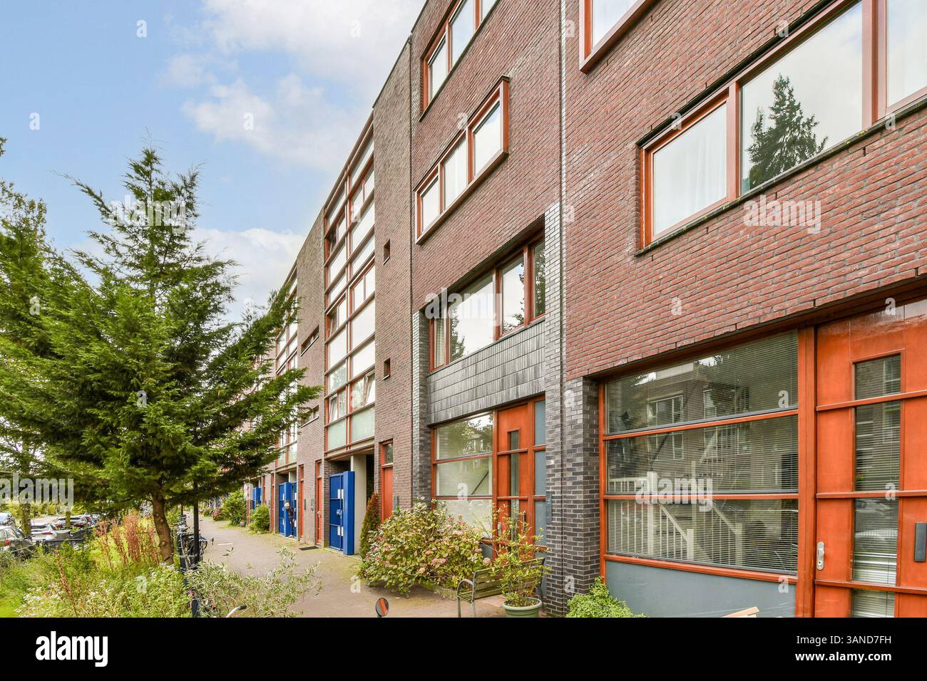 The image showcases a modern urban building with large windows, a ...