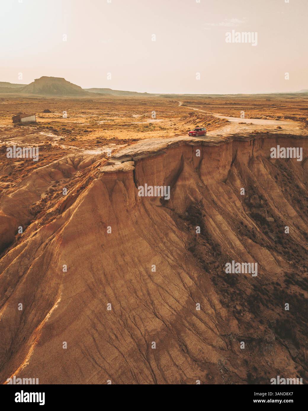 Aerial view of a red car on a cliff, Bardenas Reales, Navarra, Spain ...