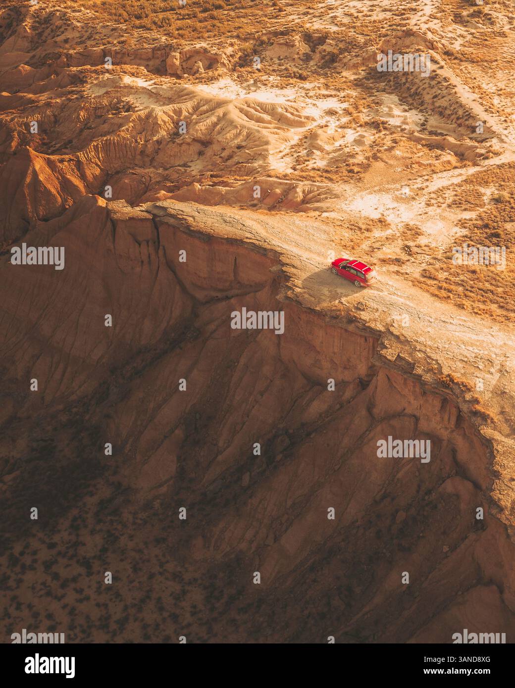 Aerial view of a red car on a cliff, Bardenas Reales, Navarra, Spain ...