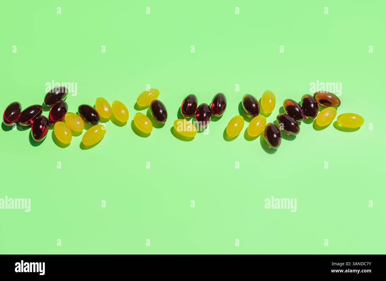 oval caps of yellow and red color with a dietary supplement, vitamins ...
