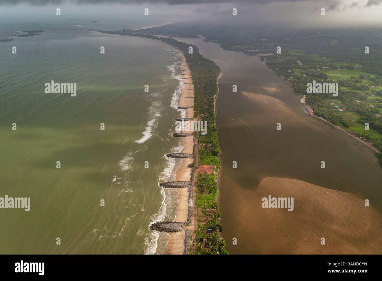 Aerial view of breakwater along a strip of land with Pithrody beach and ...