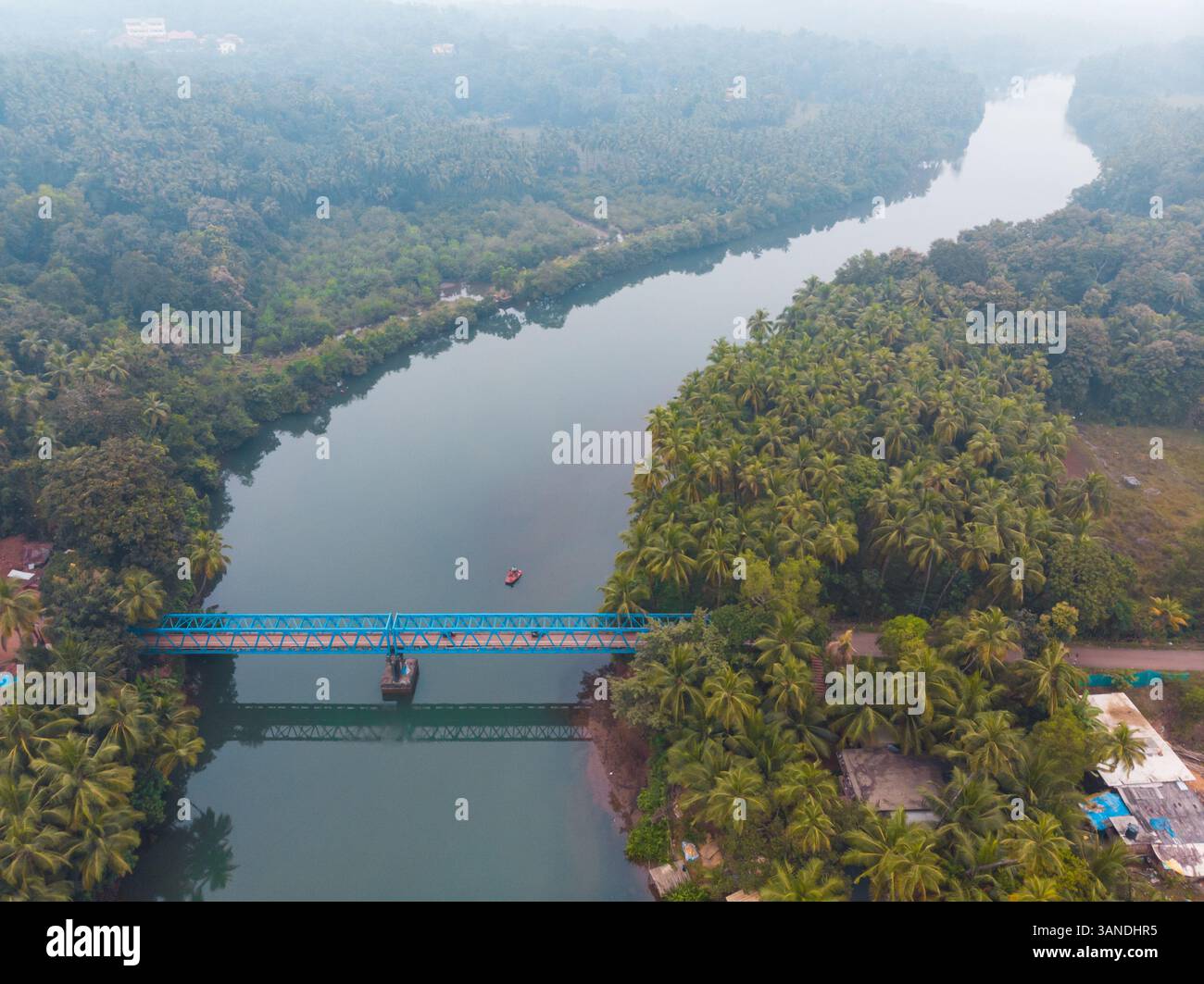 Aerial view of Sadolxem bridge over Talpon river with a boat in ...
