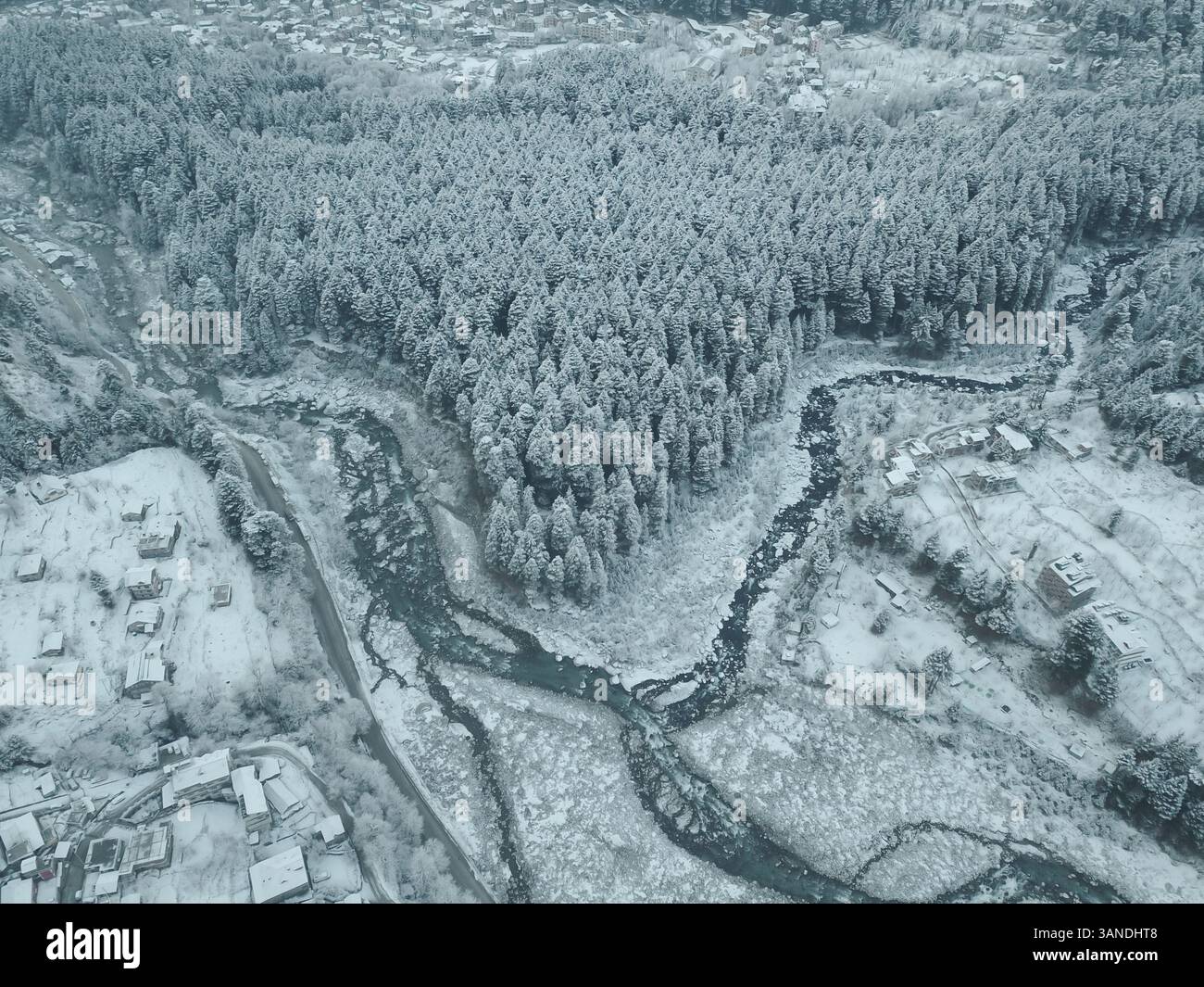 Early morning aerial view of snow-covered Manali city overlooking Beas ...