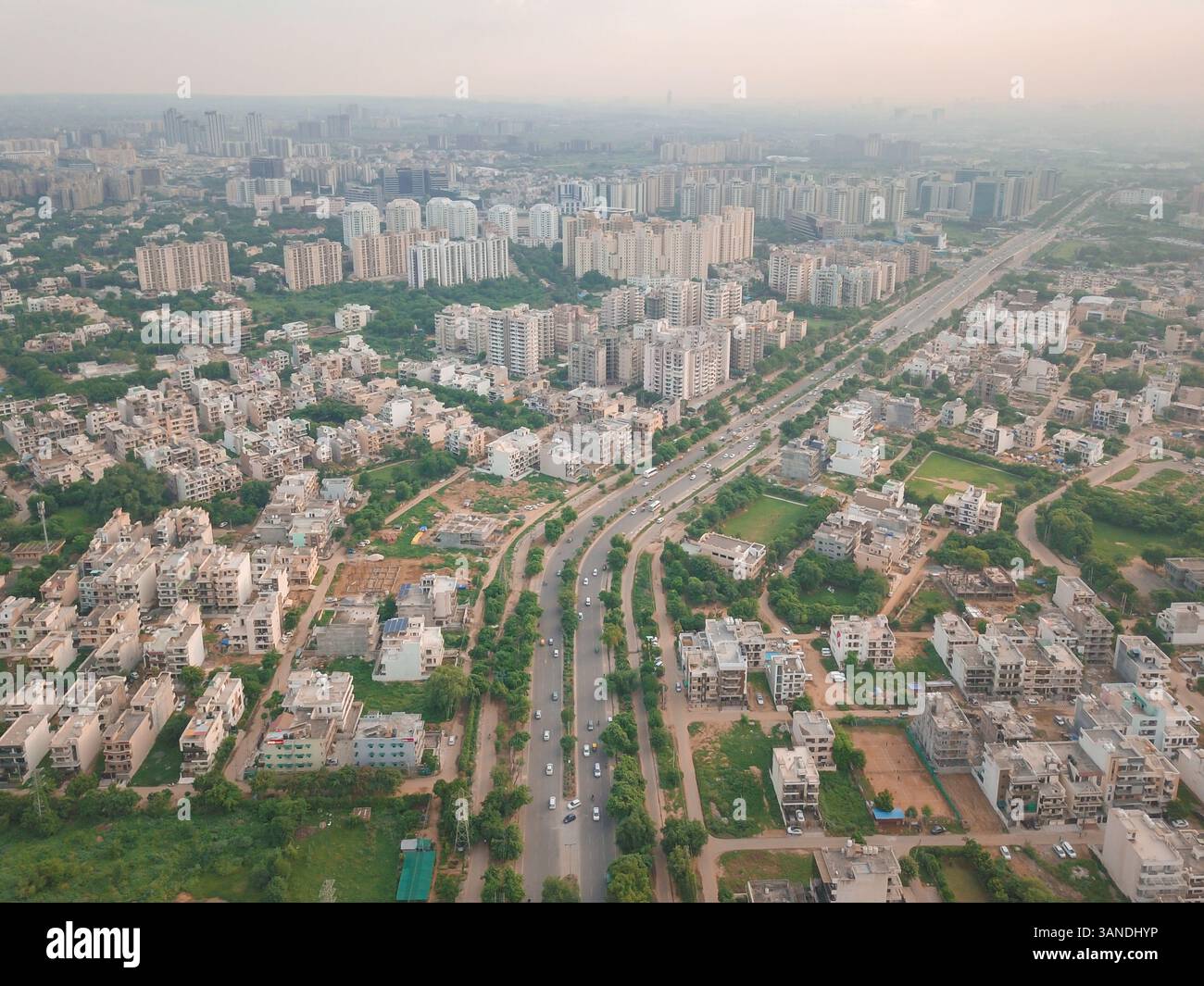 Aerial view of cars passing through a 2 way in urbanized gurgaon sector ...
