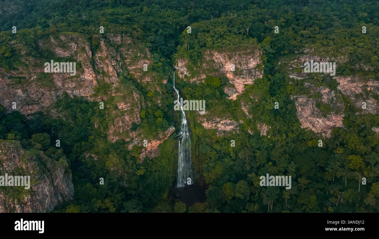 Aerial view of a majestic waterfall cascading down a lush cliff ...