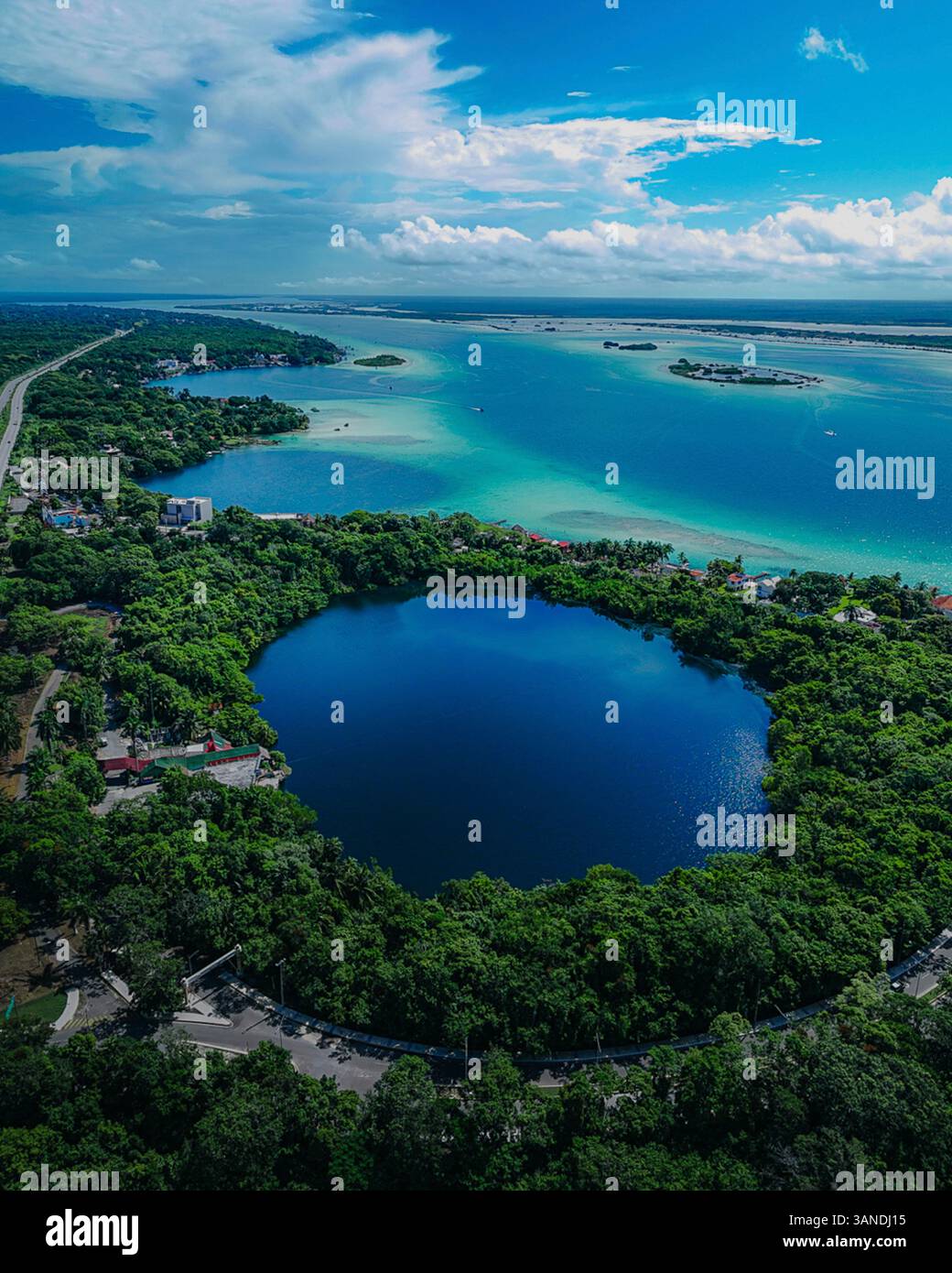 Aerial view of serene Xenote Azul lagoon surrounded by lush forest and ...
