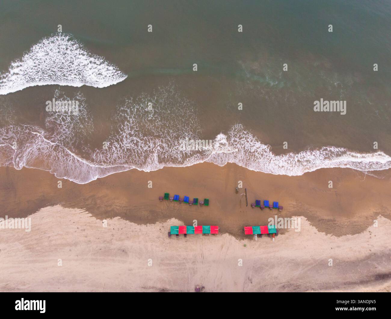 Top down aerial view of waves on mandrem beach in Goa state of India ...