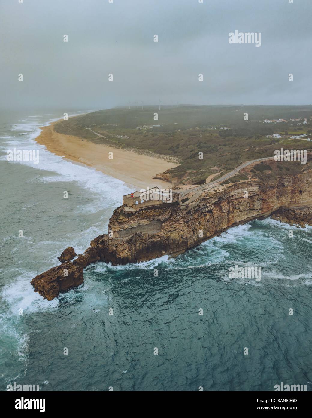 Aerial view of the rocky coastline with a lighthouse and sandy beach ...