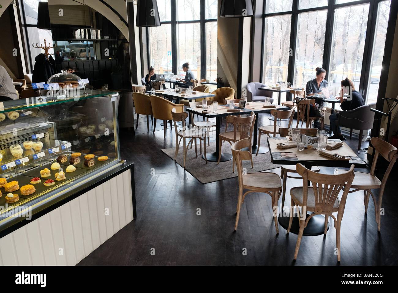 Cafe visitors in a half-empty room Stock Photo - Alamy
