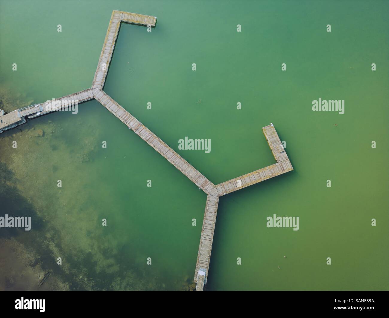 Aerial view of serene Lago di Viverone with a tranquil pier and scenic ...
