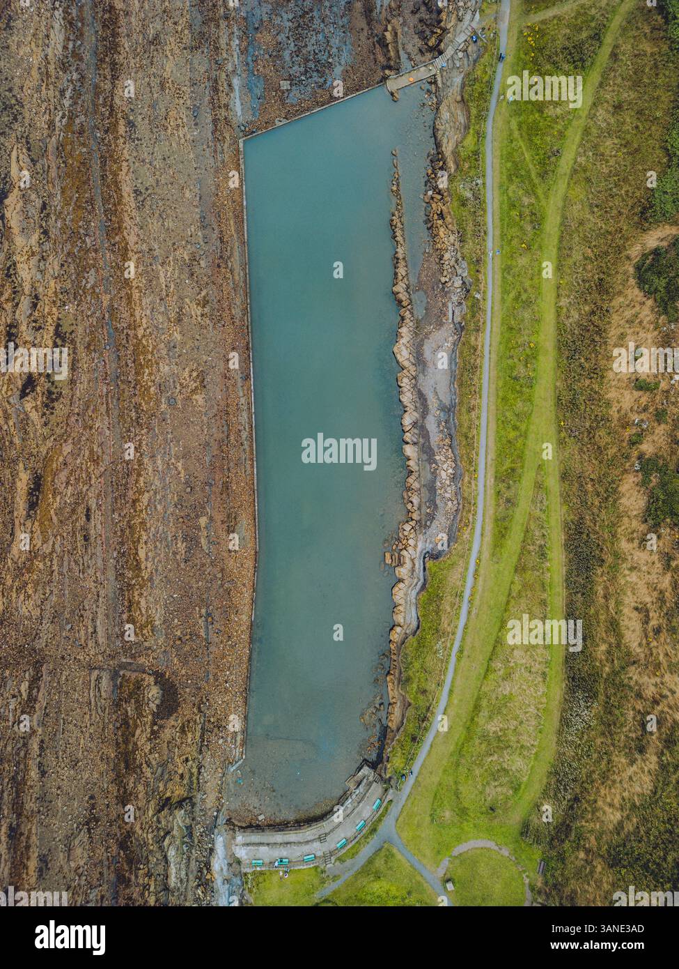 Aerial view of serene St Monans tidal pool surrounded by rocky terrain ...