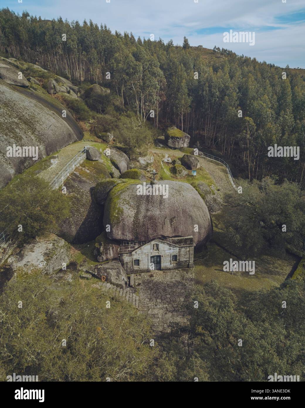 Aerial view of historic house surrounded by forest and rock formations ...