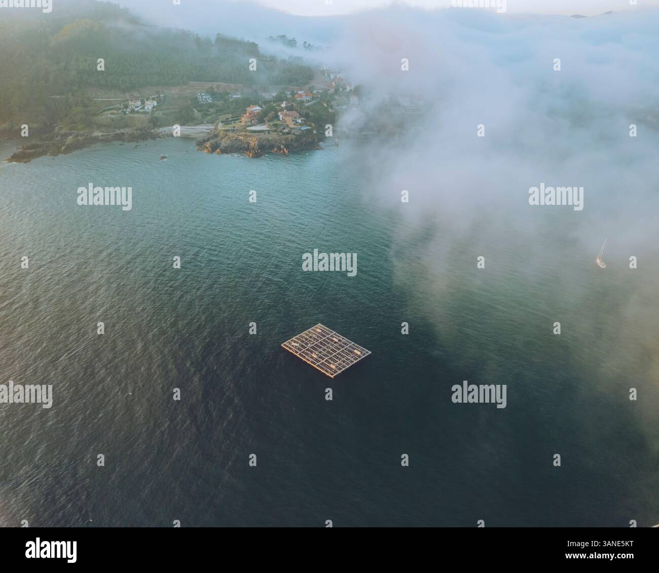 Aerial view of Galicia's coastal town Monteferro with misty morning fog ...