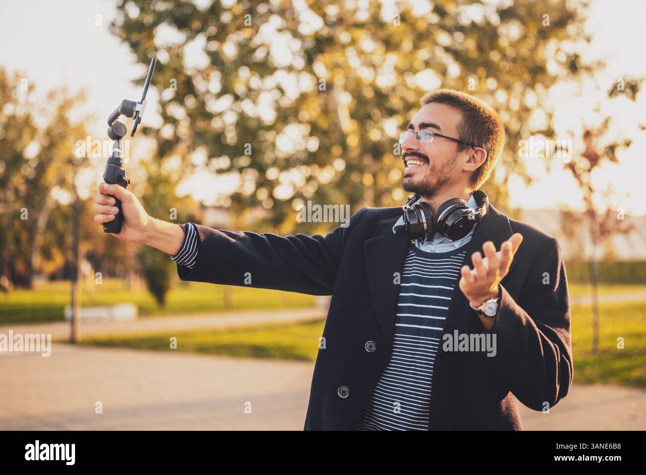 Business influencer using stabilizer and mobile phone for recording ...