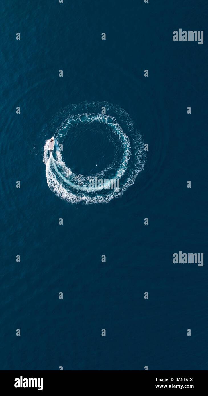 Aerial view of a boat driving in circle in the sea Stock Photo - Alamy