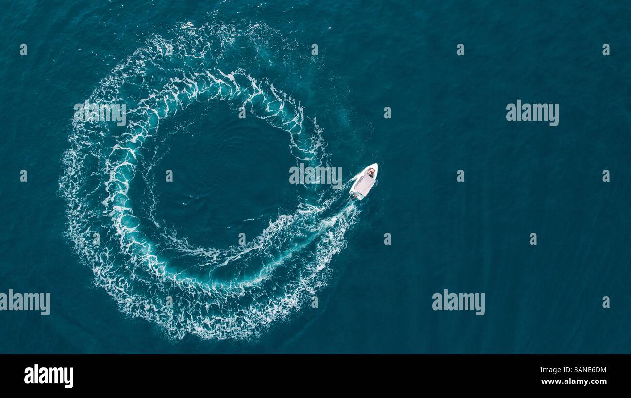 Aerial view of a boat driving in circle in the sea Stock Photo - Alamy
