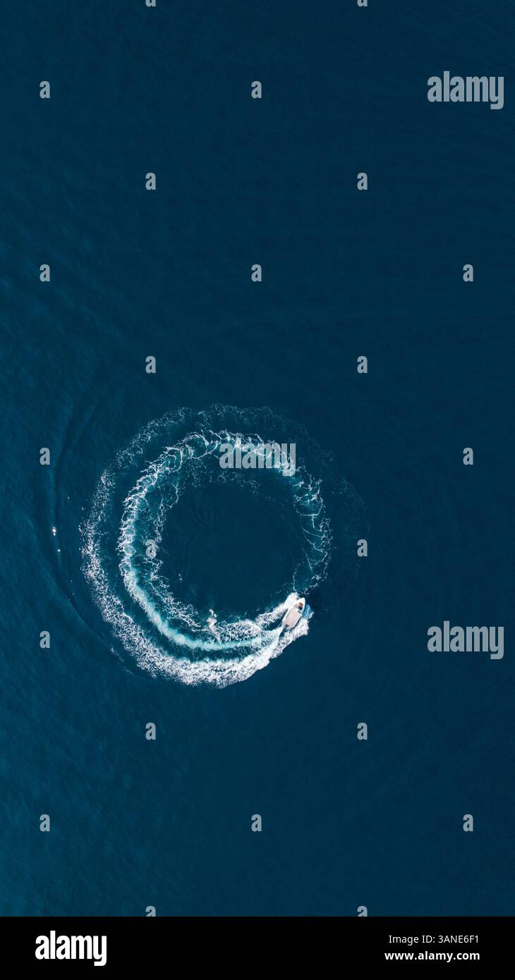 Aerial view of a boat driving in circle in the sea Stock Photo - Alamy