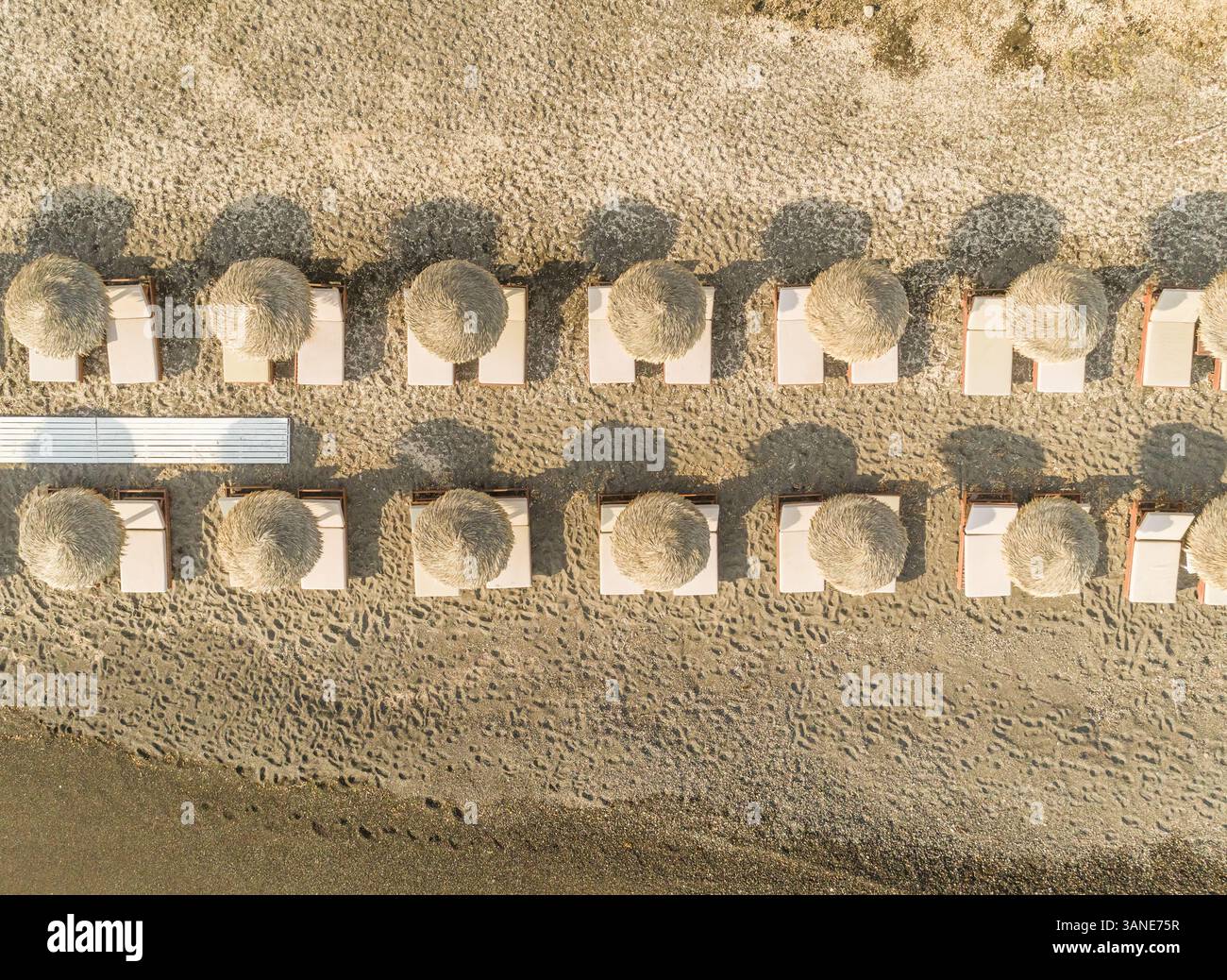 Aerial view of beach with thatch parasols on Santorini island, Greece ...