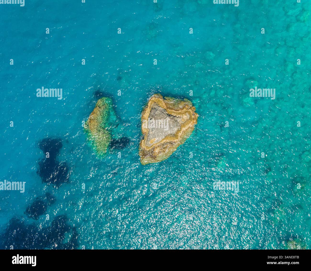 Aerial view of isolated rock formation island in the mediterranean ...