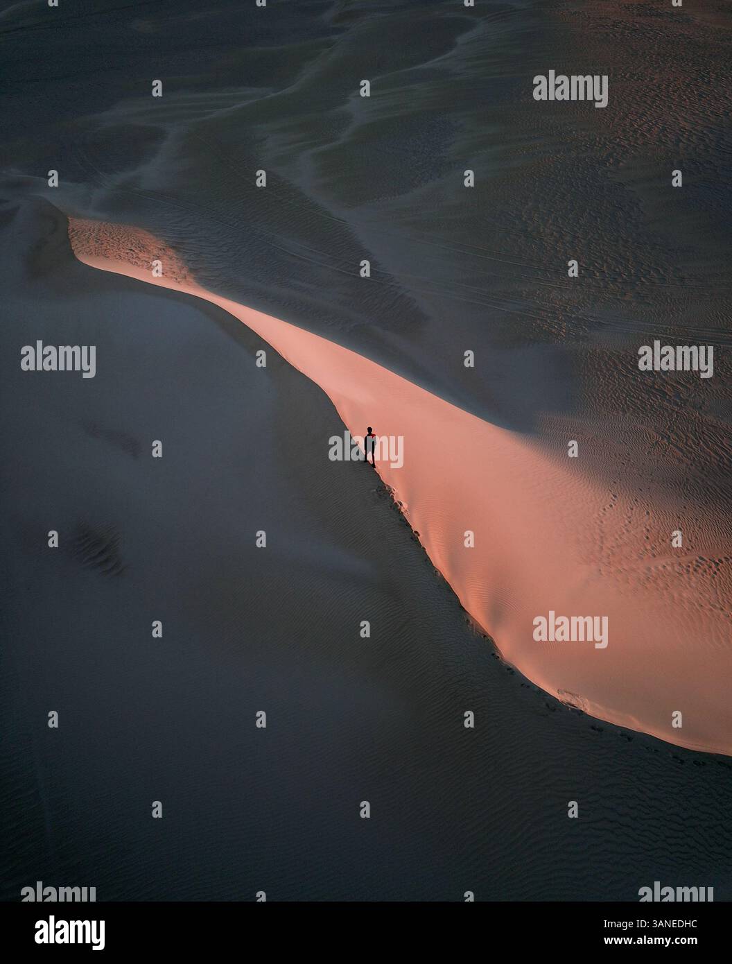 Aerial view of someone exploring during sunrise on the Lancelin Sand ...