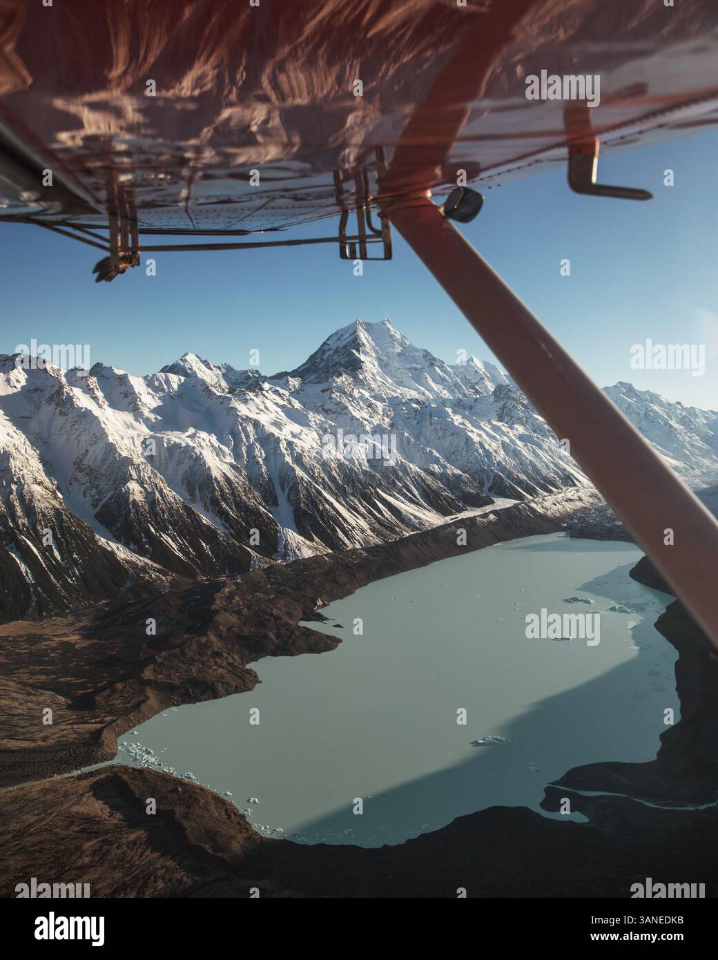 Aerial view from airplane window of snowy mountain peak Mount Cook ...