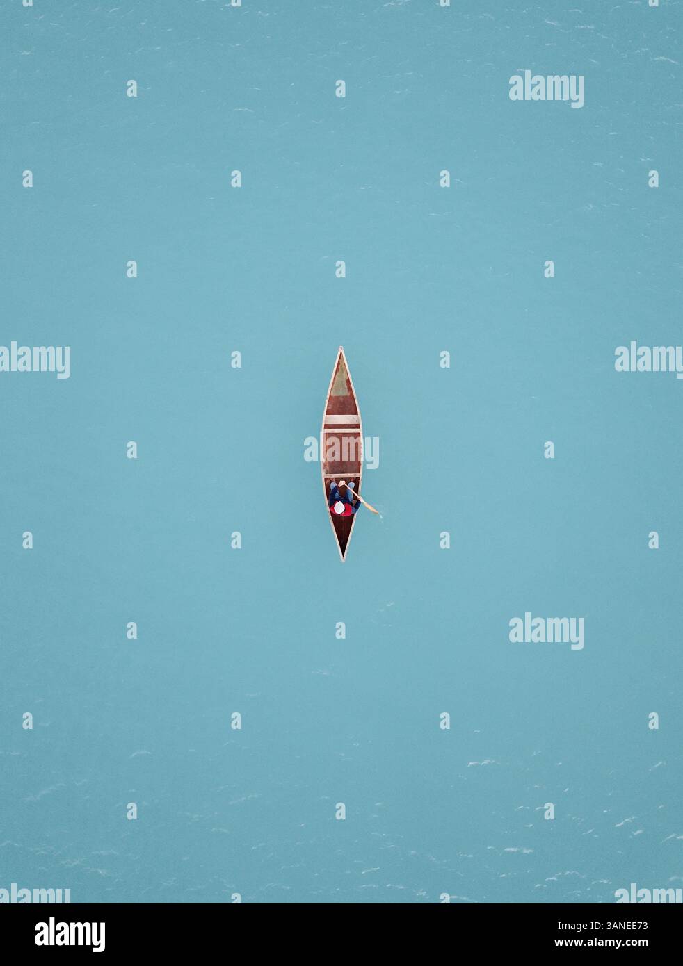 Aerial view of a classic Canadian canoe paddling on glacial turquoise ...