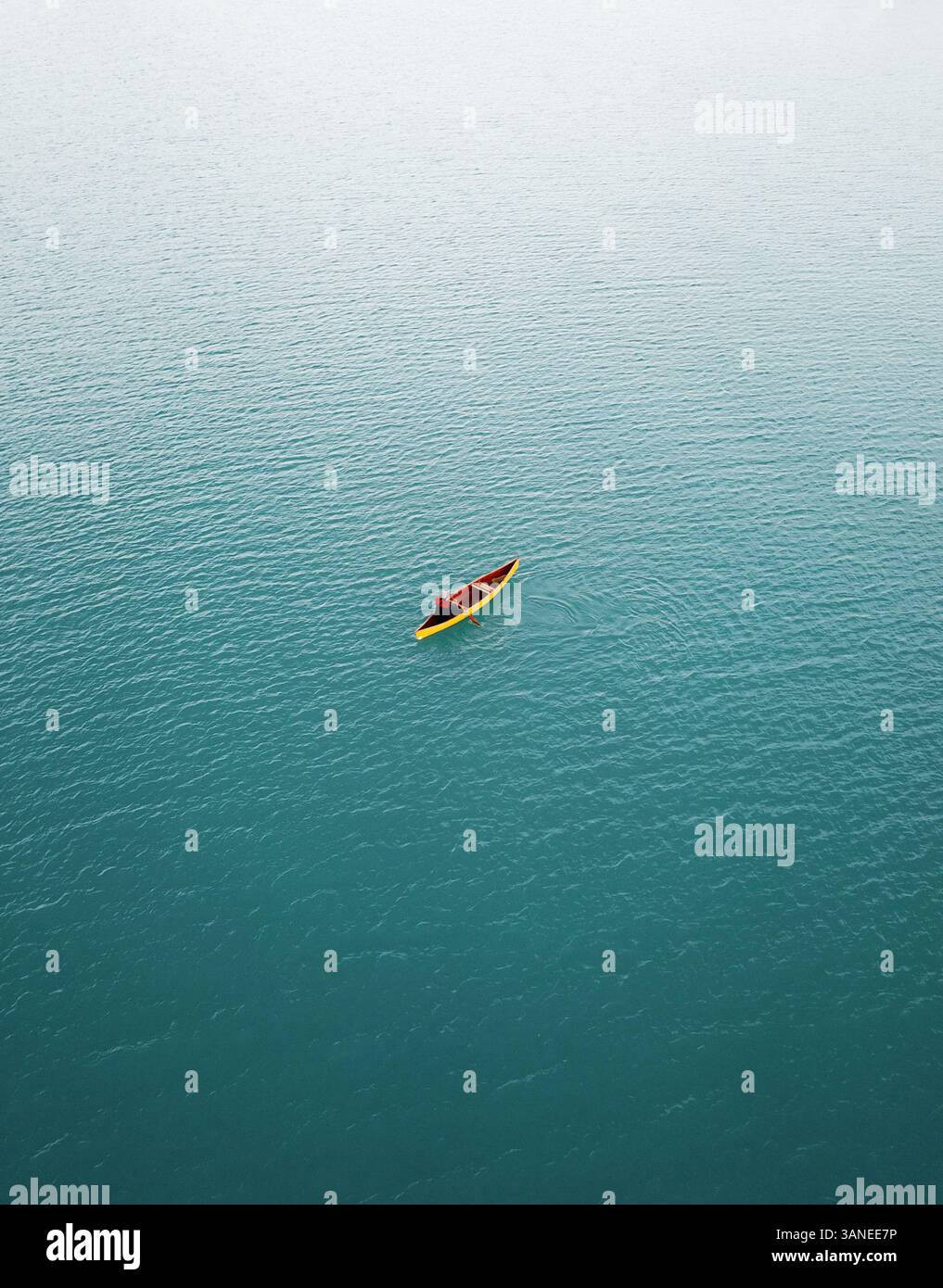 Aerial view of a classic Canadian canoe paddling on glacial turquoise ...