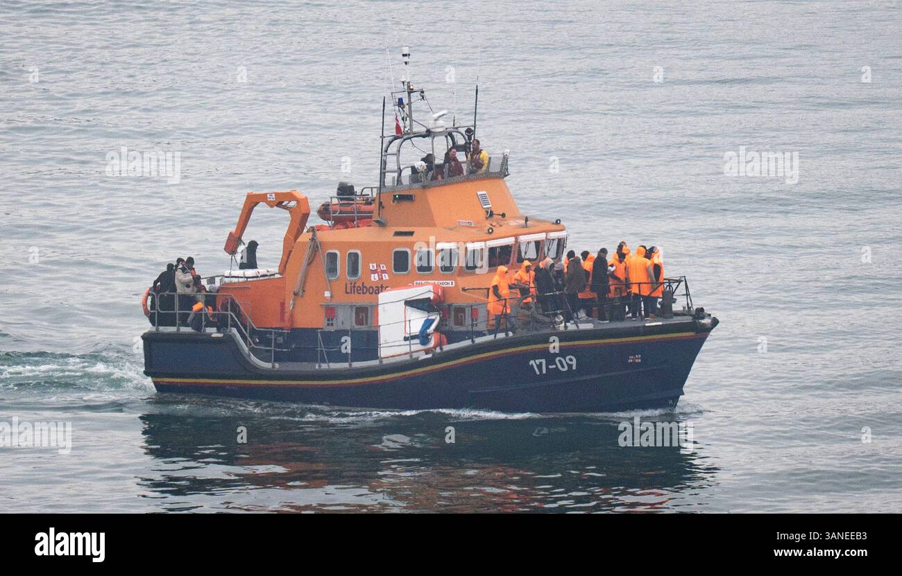 A group of people thought to be migrants are brought in to Dover, Kent ...