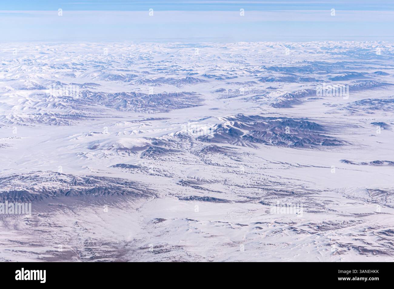 Breathtaking high-altitude view of the snow-capped Tangula Mountains on ...