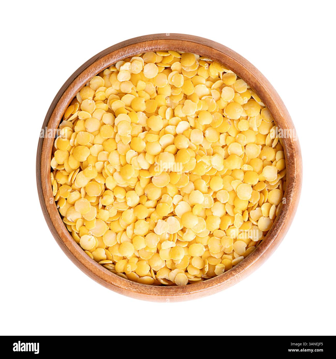 Yellow lentils in a wooden bowl. Dried seeds of a variety of Lens ...