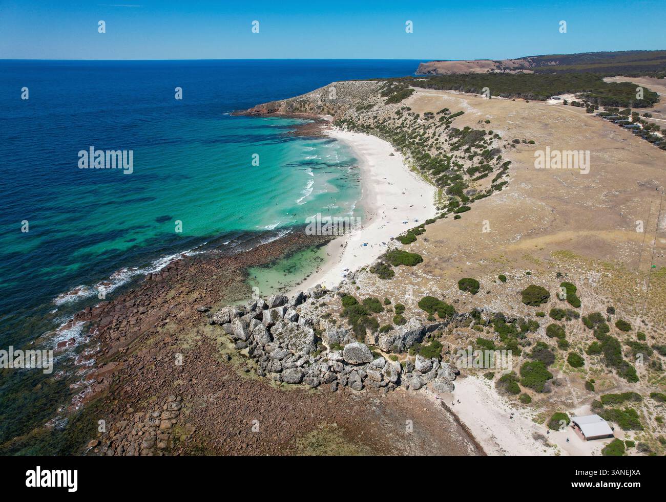 Aerial view of Stokes Bay Beach with clear water and rocky coastline ...