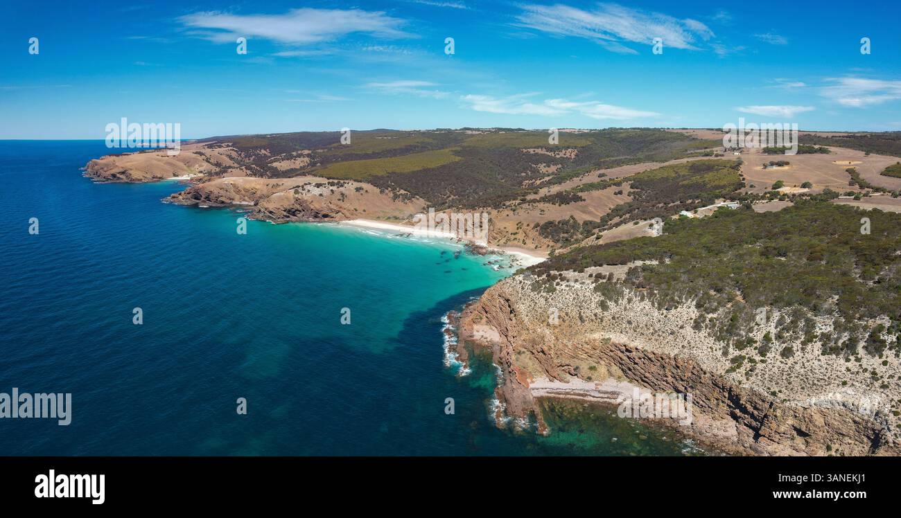 Aerial view of deep gully creek beach with rugged cliffs and tranquil ...