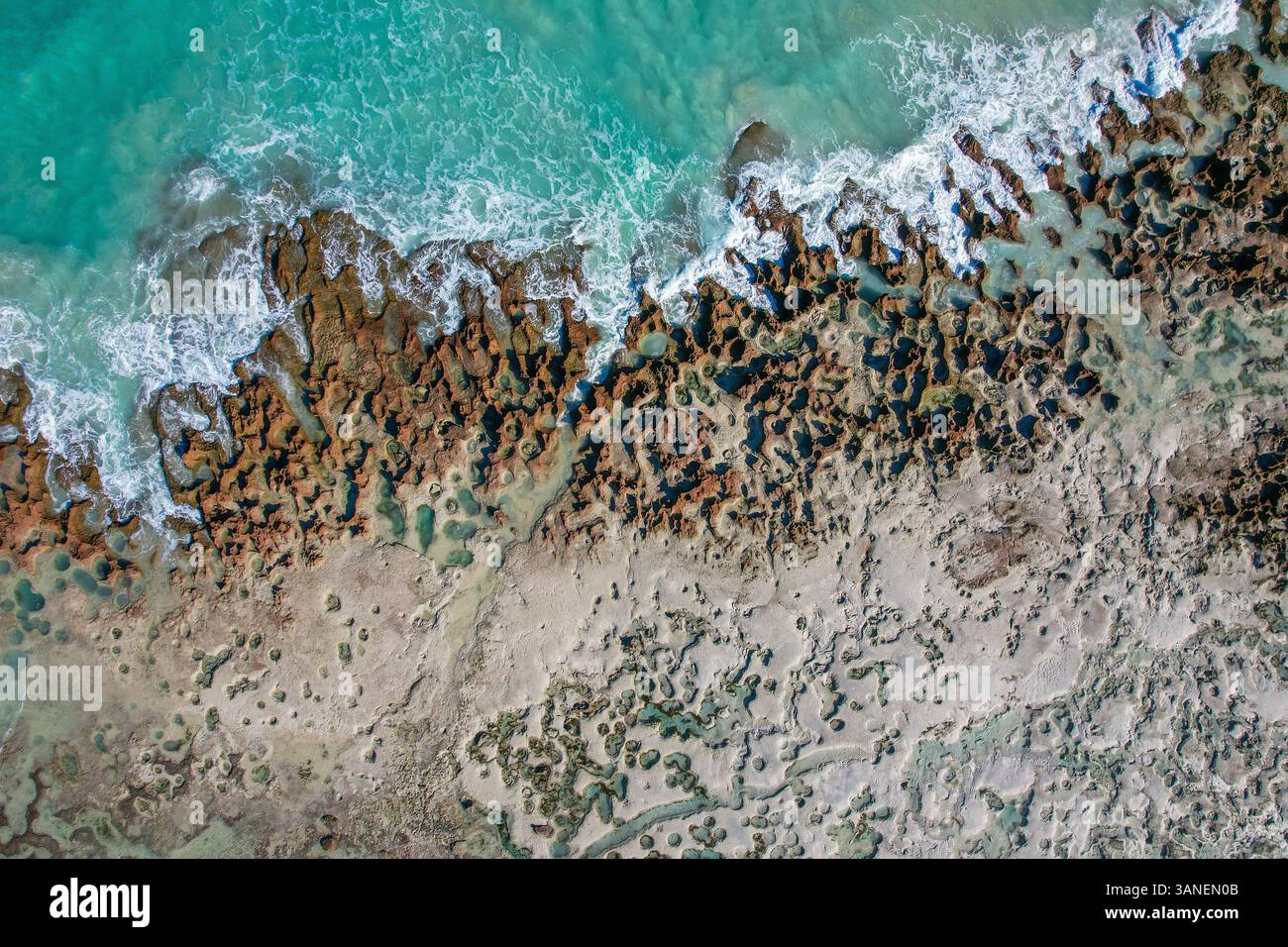 Aerial view of beautiful rock formations and turquoise ocean waves at ...
