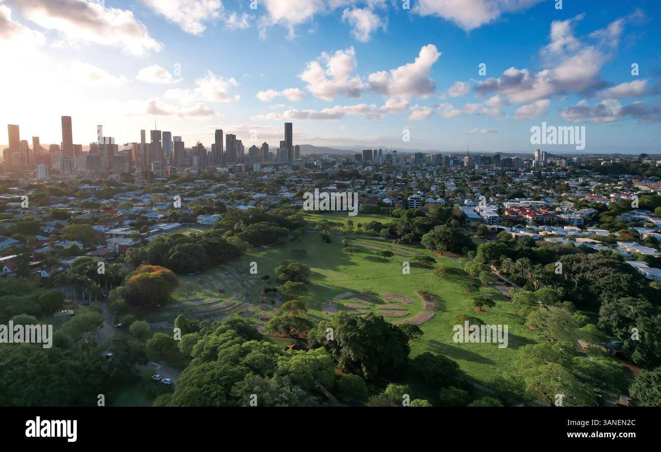 Aerial view of new farm park with lush greenery and urban skyline at ...