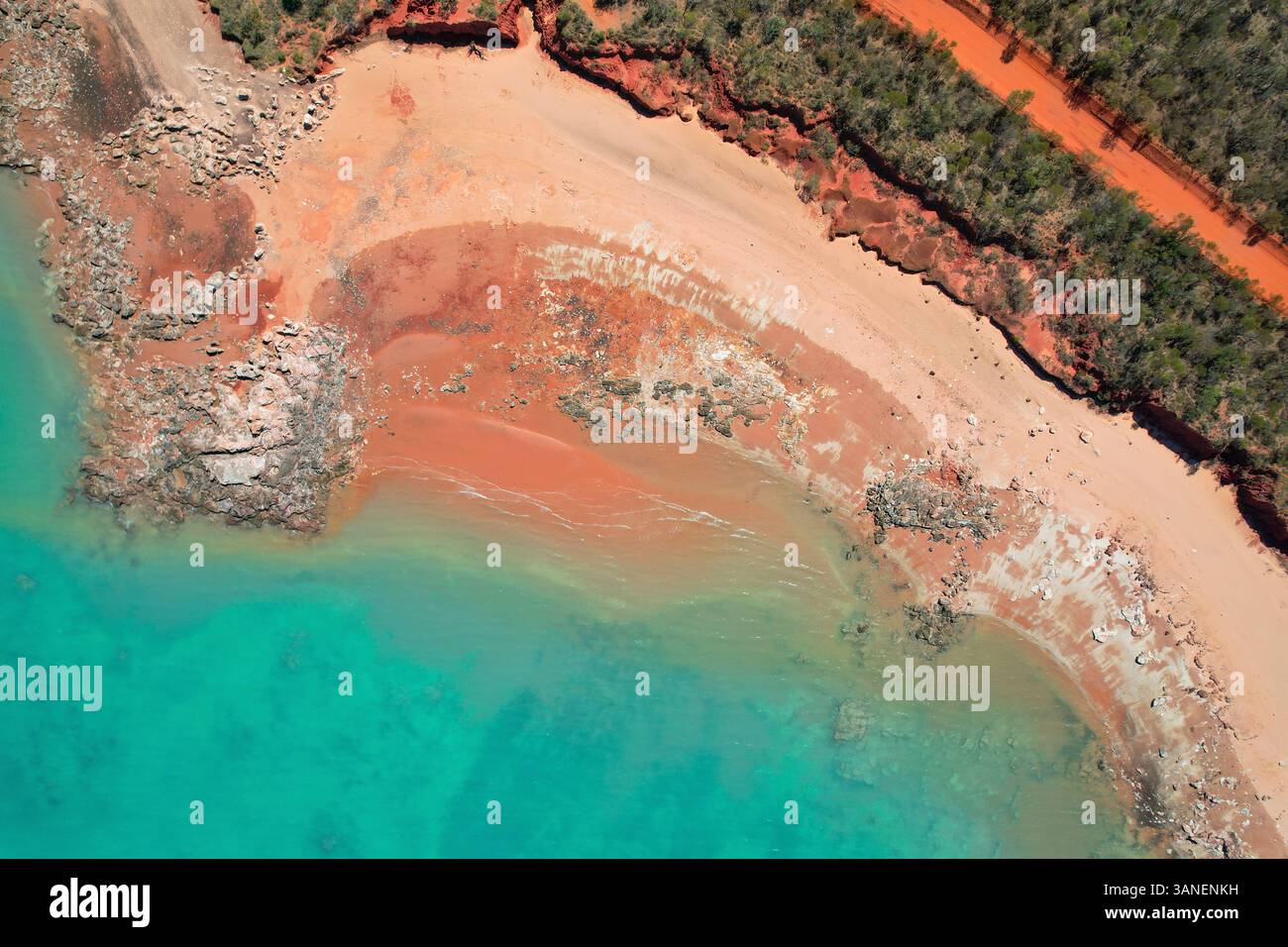 Aerial view of red sand beach and azure ocean with beautiful coastline ...