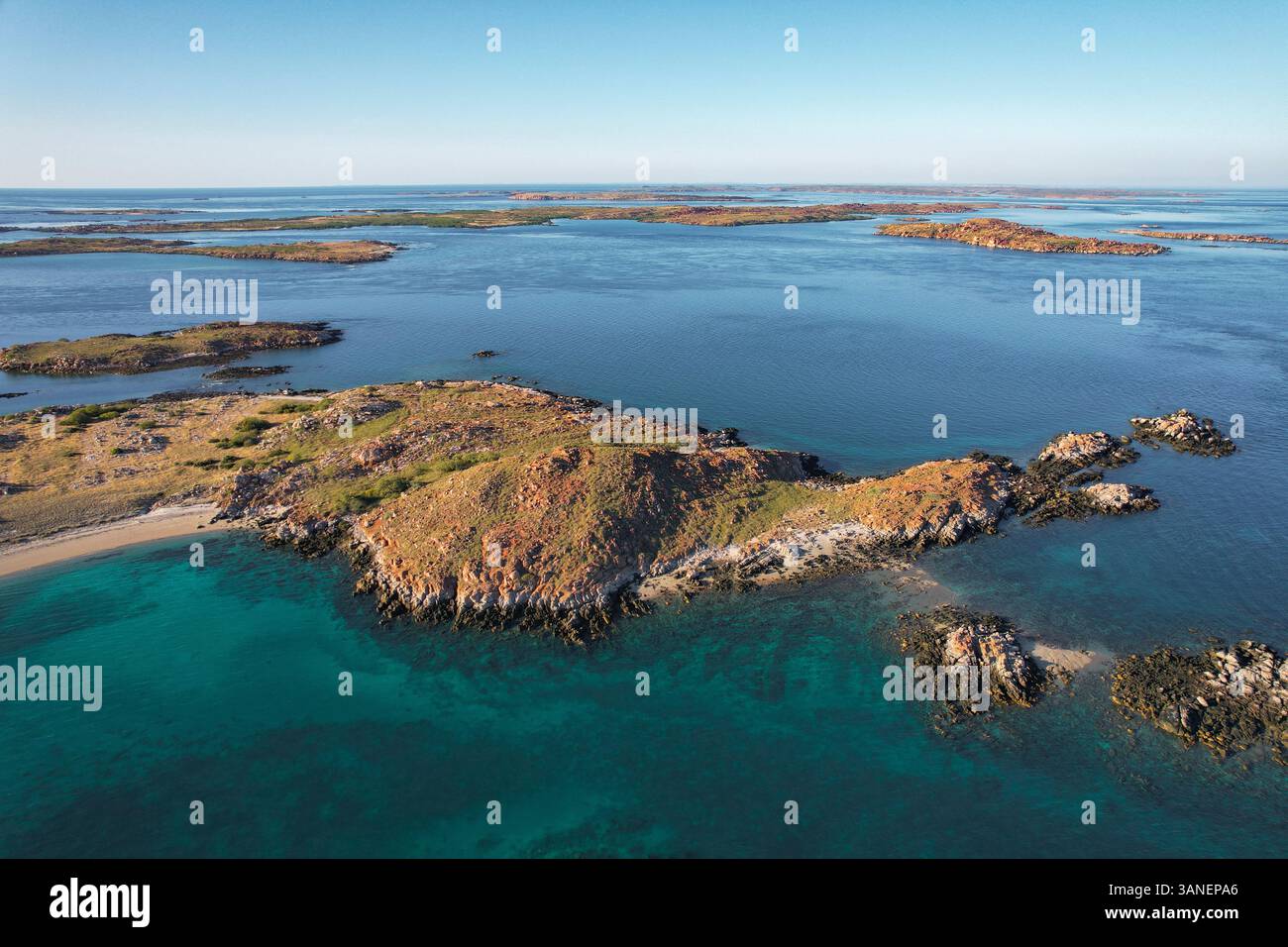 Aerial view of beautiful coastal landscape with island and ocean waves ...