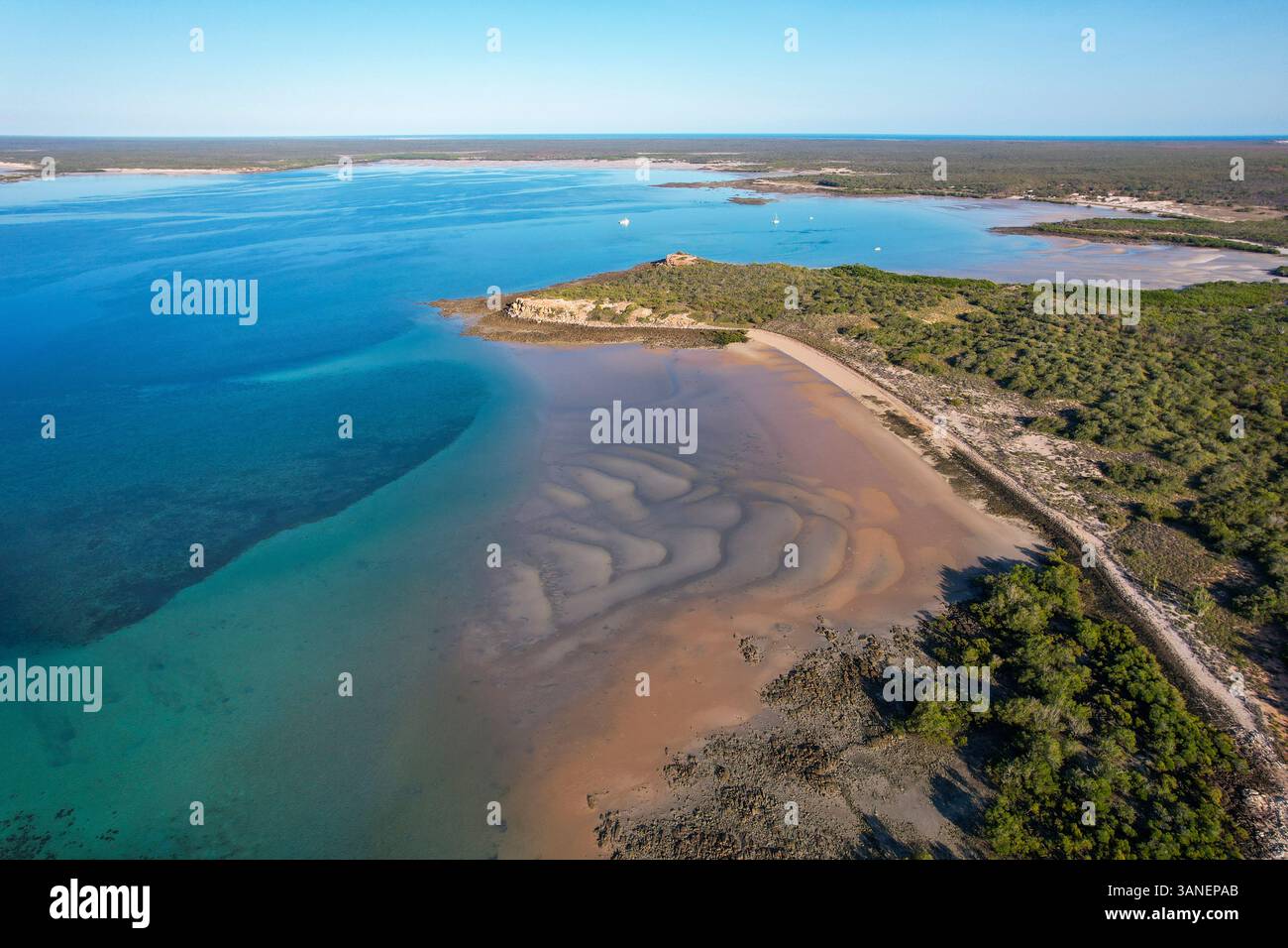Aerial view of serene mudflats and beautiful coastline with blue water ...