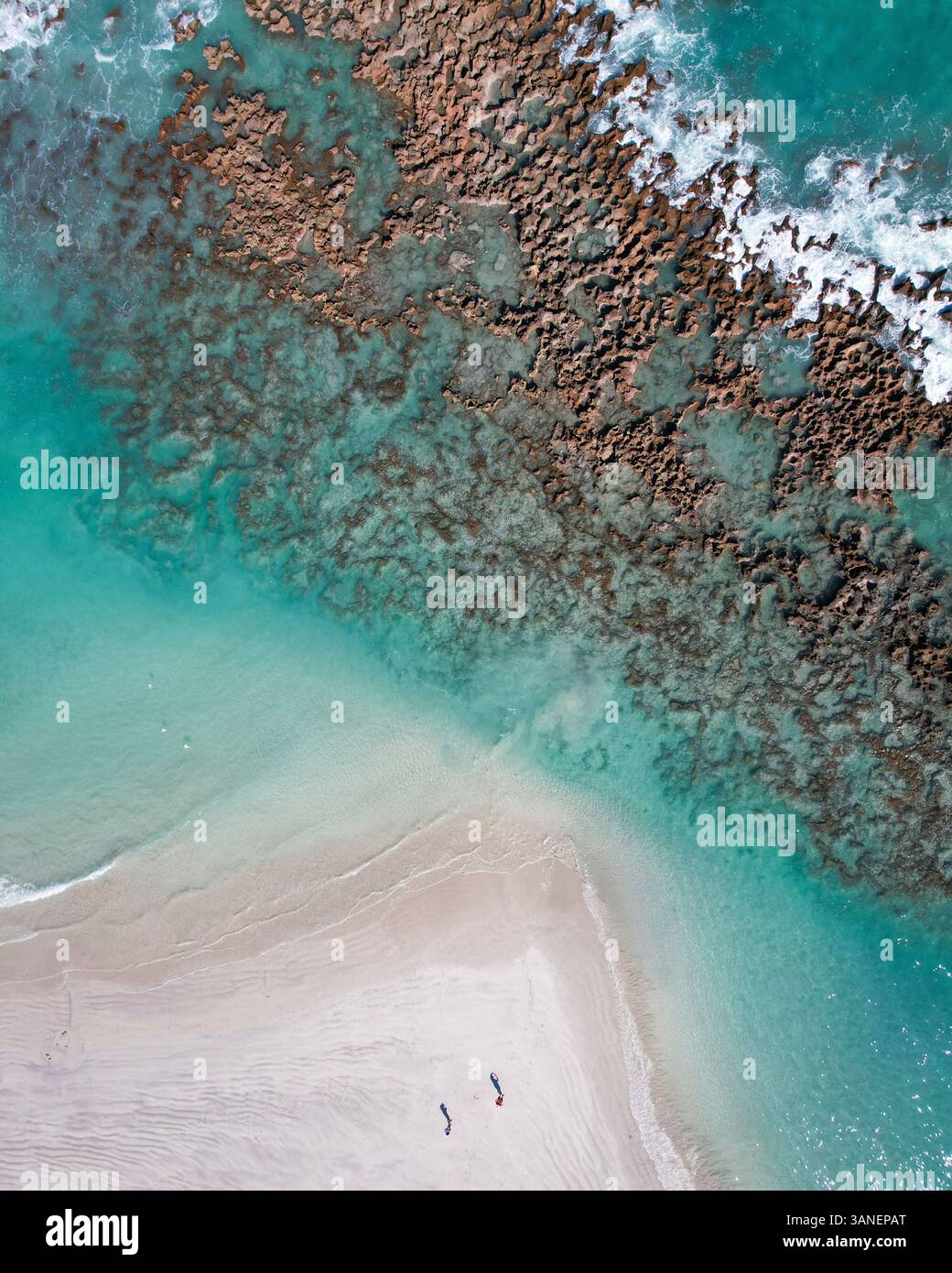 Aerial view of coconut well rock pools with beachgoers on a beautiful ...