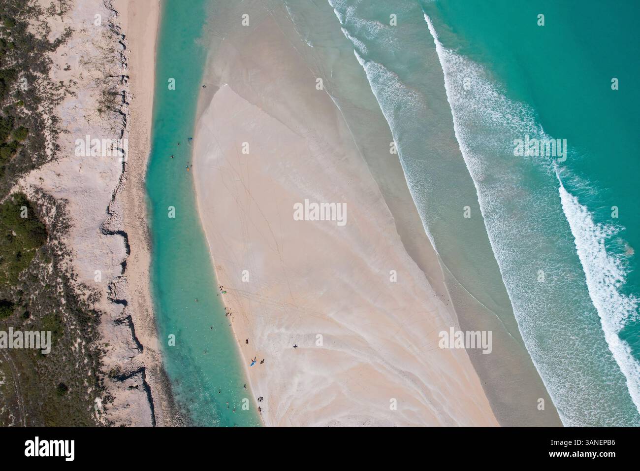Aerial view of coconut well lagoon with beachgoers and turquoise water ...