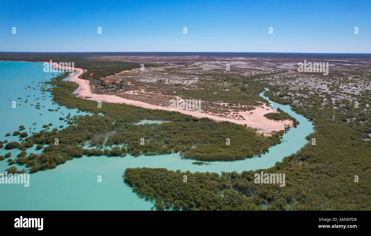 Aerial view of red sand beach and mangroves along the tranquil Roebuck ...