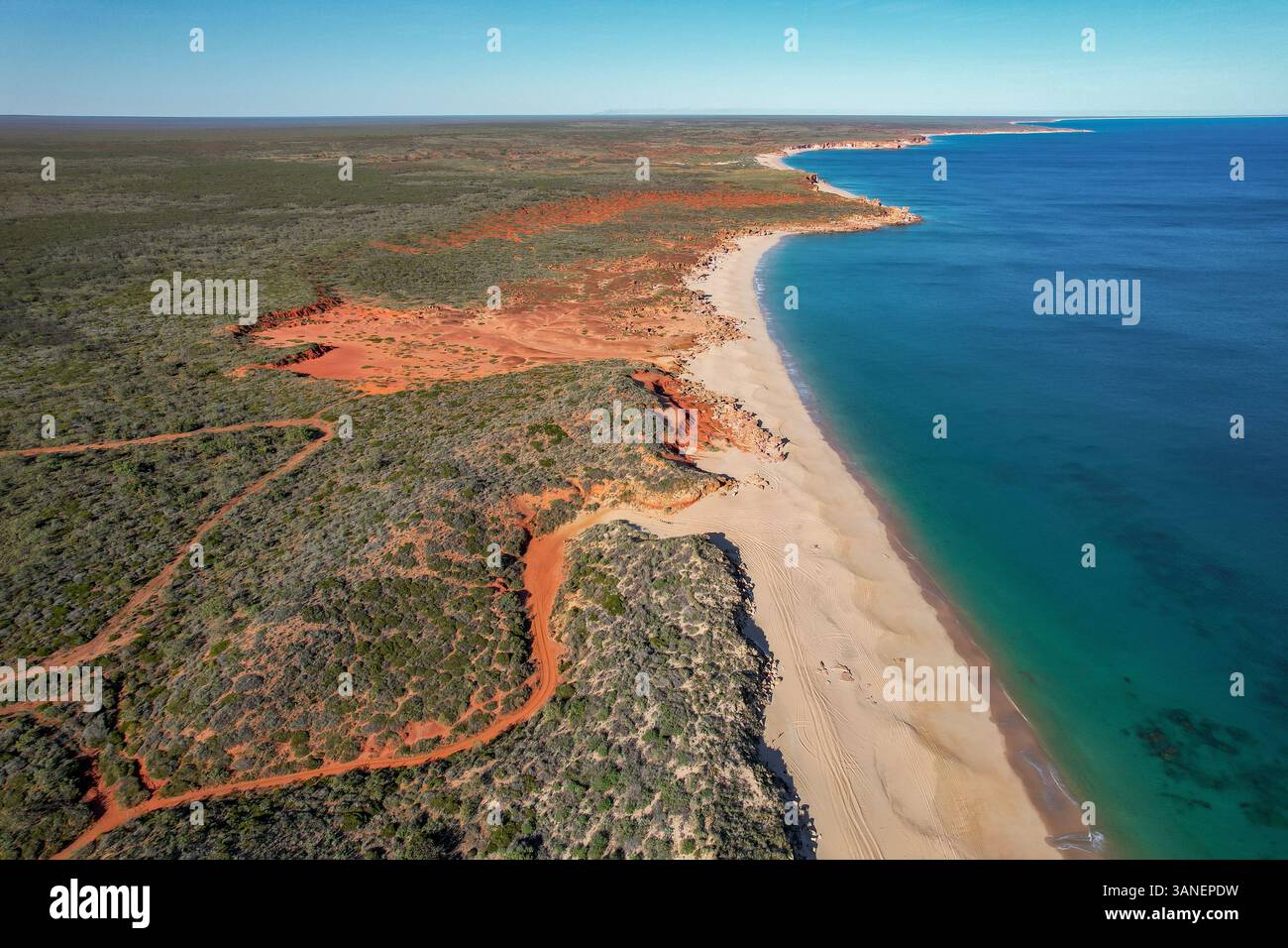 Aerial view of ochre cliffs and sandy beach along the coastline with ...