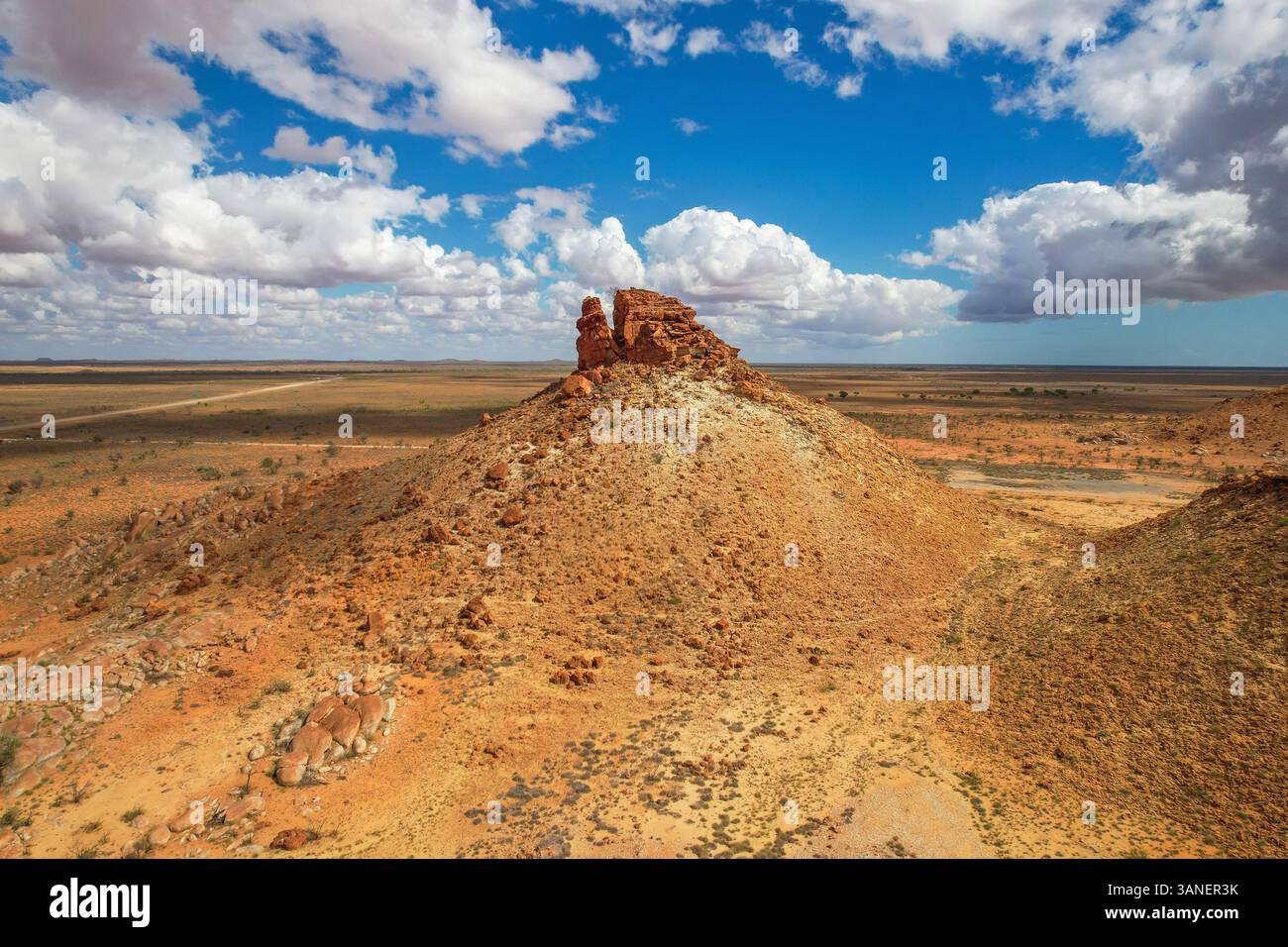 Aerial view of arid desert landscape with rugged hills and vast open ...